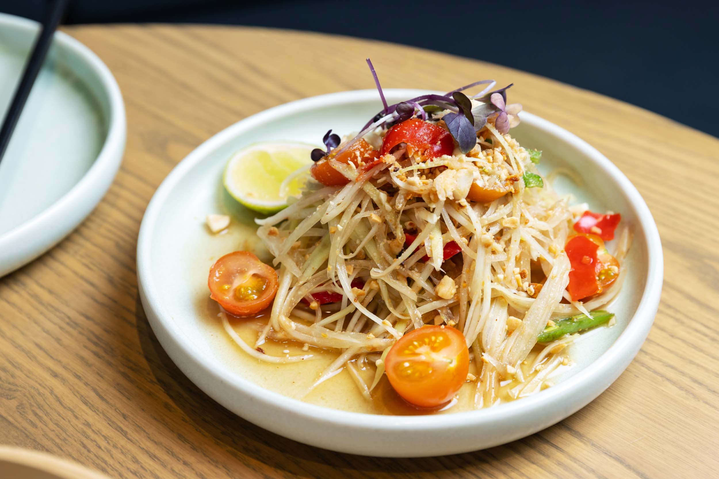 Som tam salad with young papaya, tomato, lime, tamarind & peanuts - WOMAN